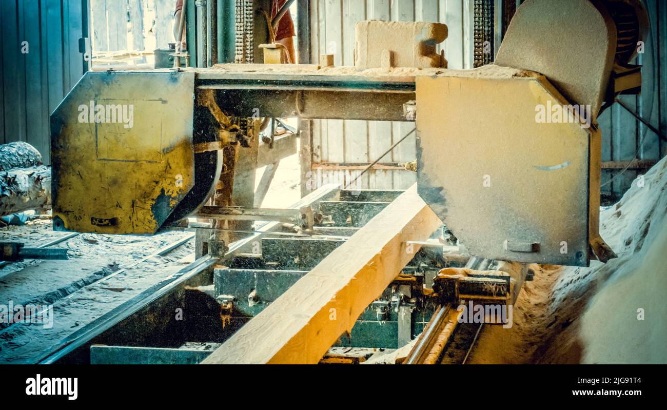 Sawmill. Process of machining logs in equipment sawmill machine saw ...