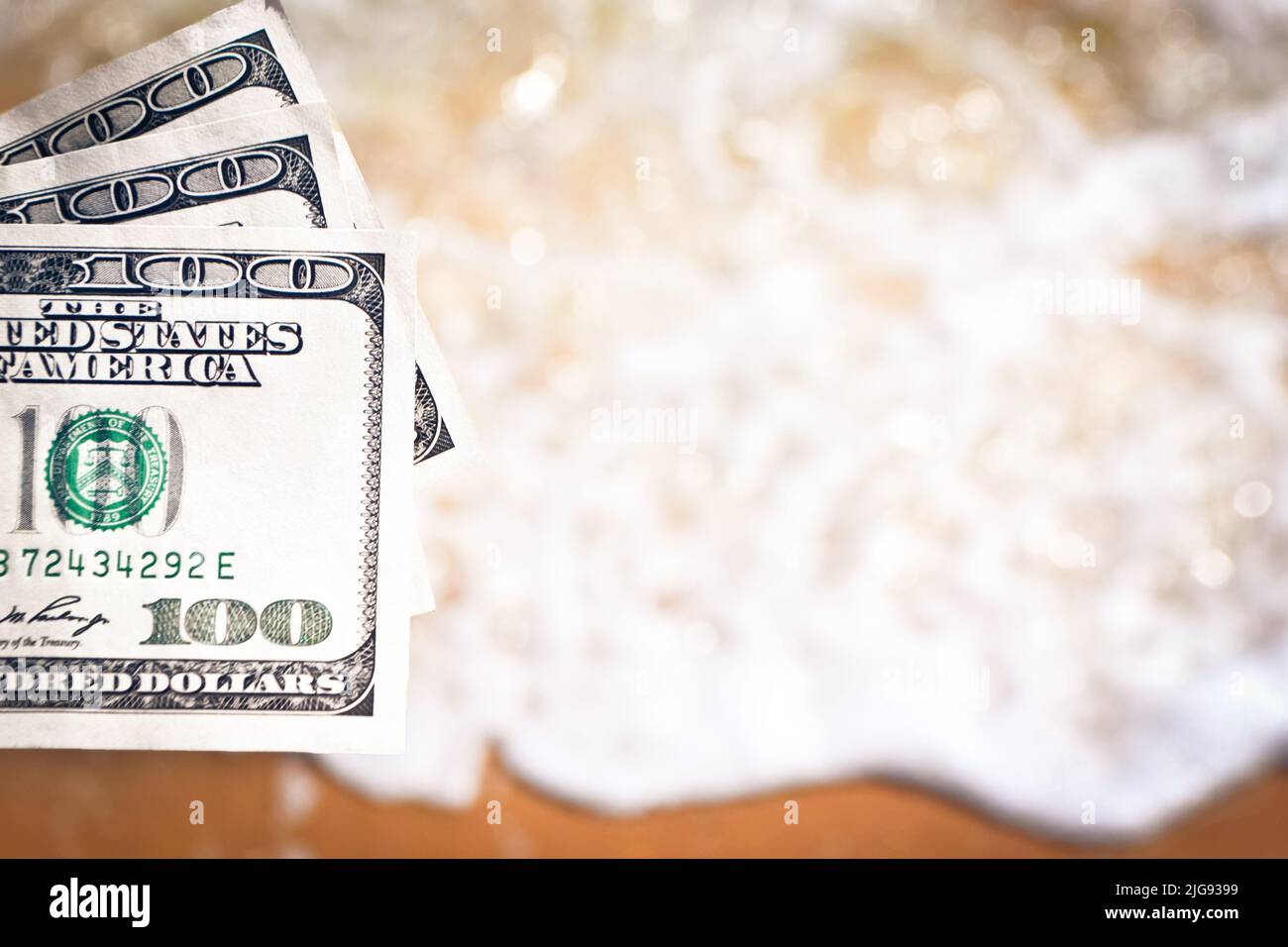 Girl holding money bill of 300 dollars on background of sea ocean waves ...