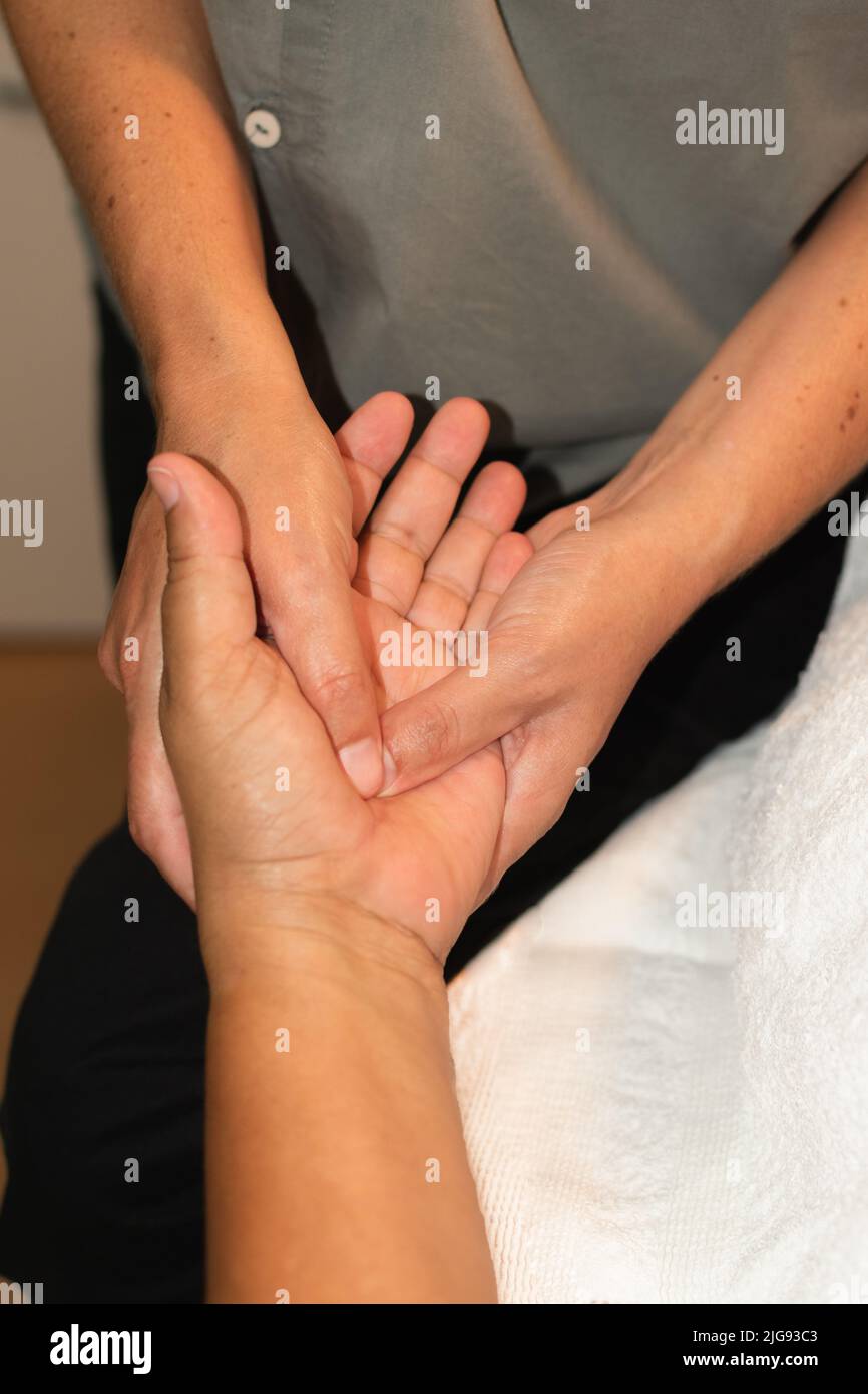 relaxing hand massage performed by a professional Stock Photo - Alamy