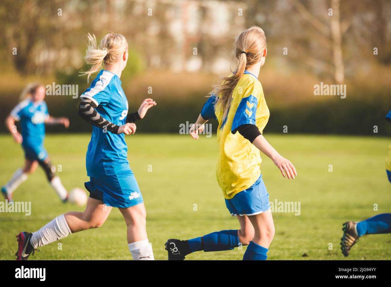 Girl playing football in field hi-res stock photography and images - Alamy