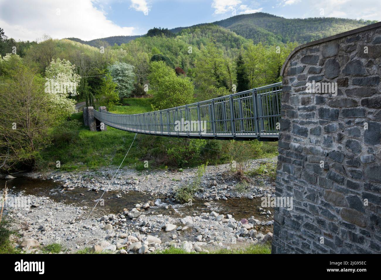 Suspension bridge over the river Aulella near the village of Casola in ...
