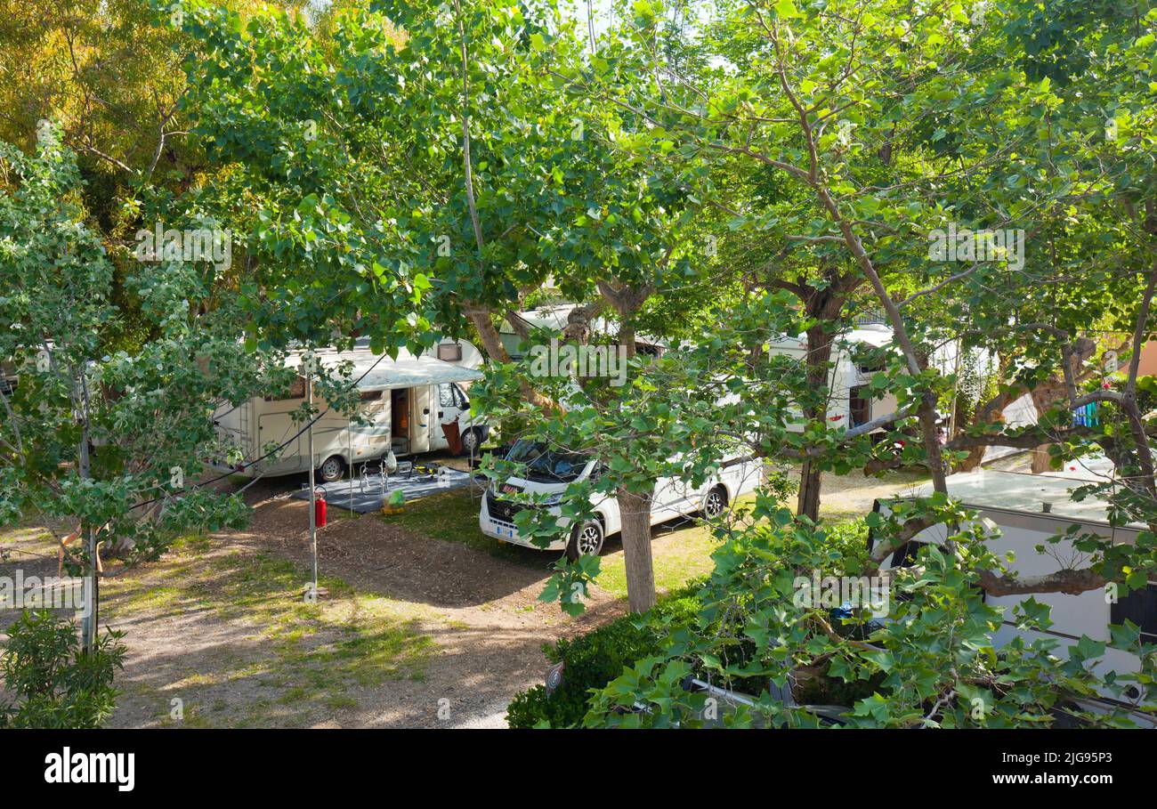Motorhomes under trees on a campsite on the island of Elba Stock Photo ...
