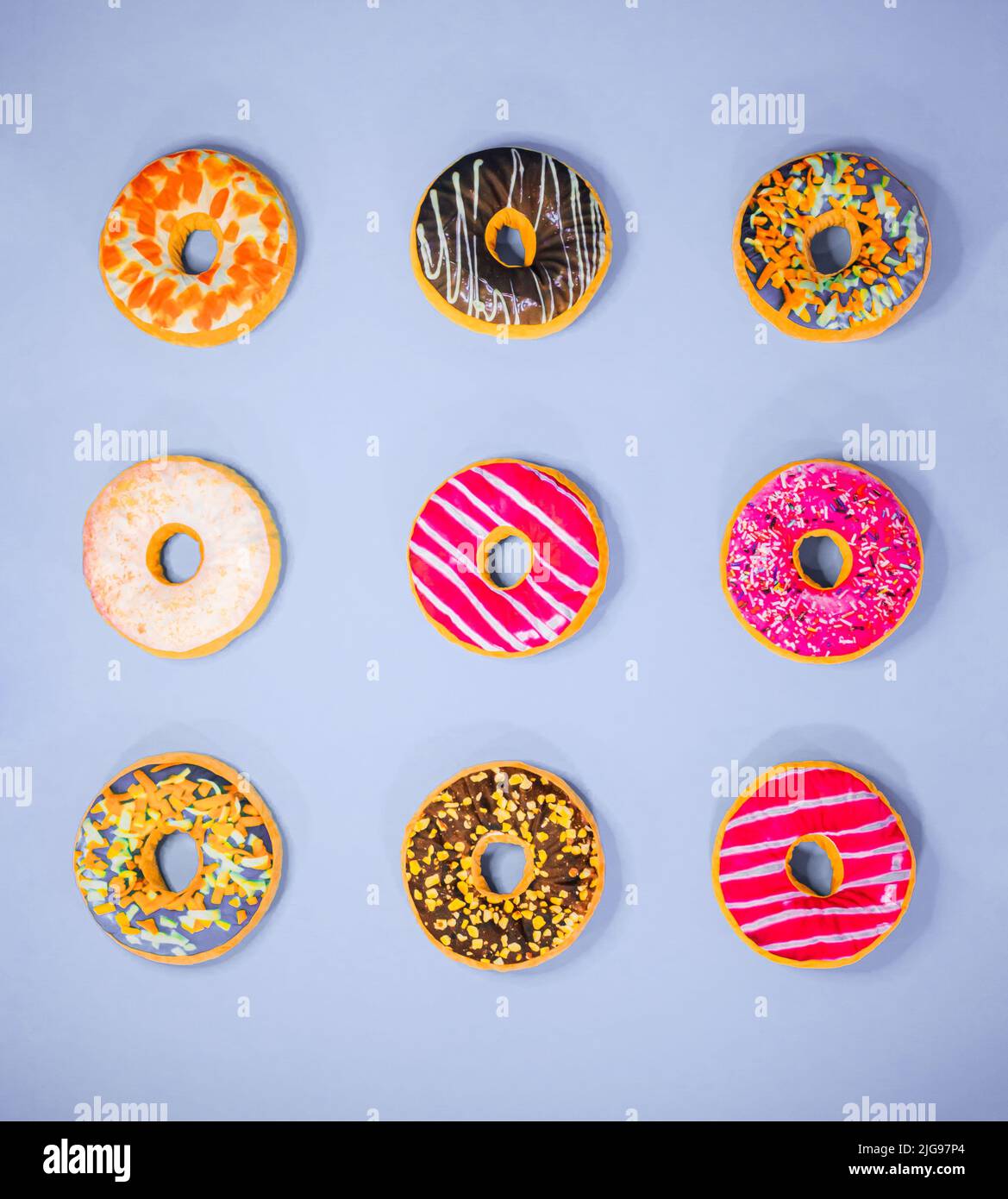 Set of 9 different colorful donuts isolated on purple background. In ...