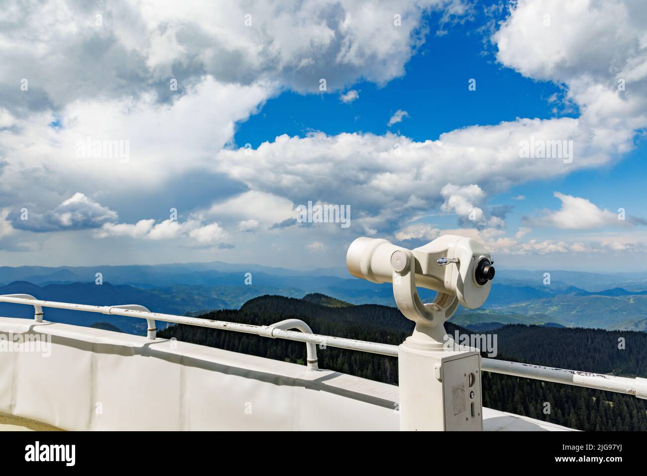 A modern metal orbital telescope of white color on a high observation ...