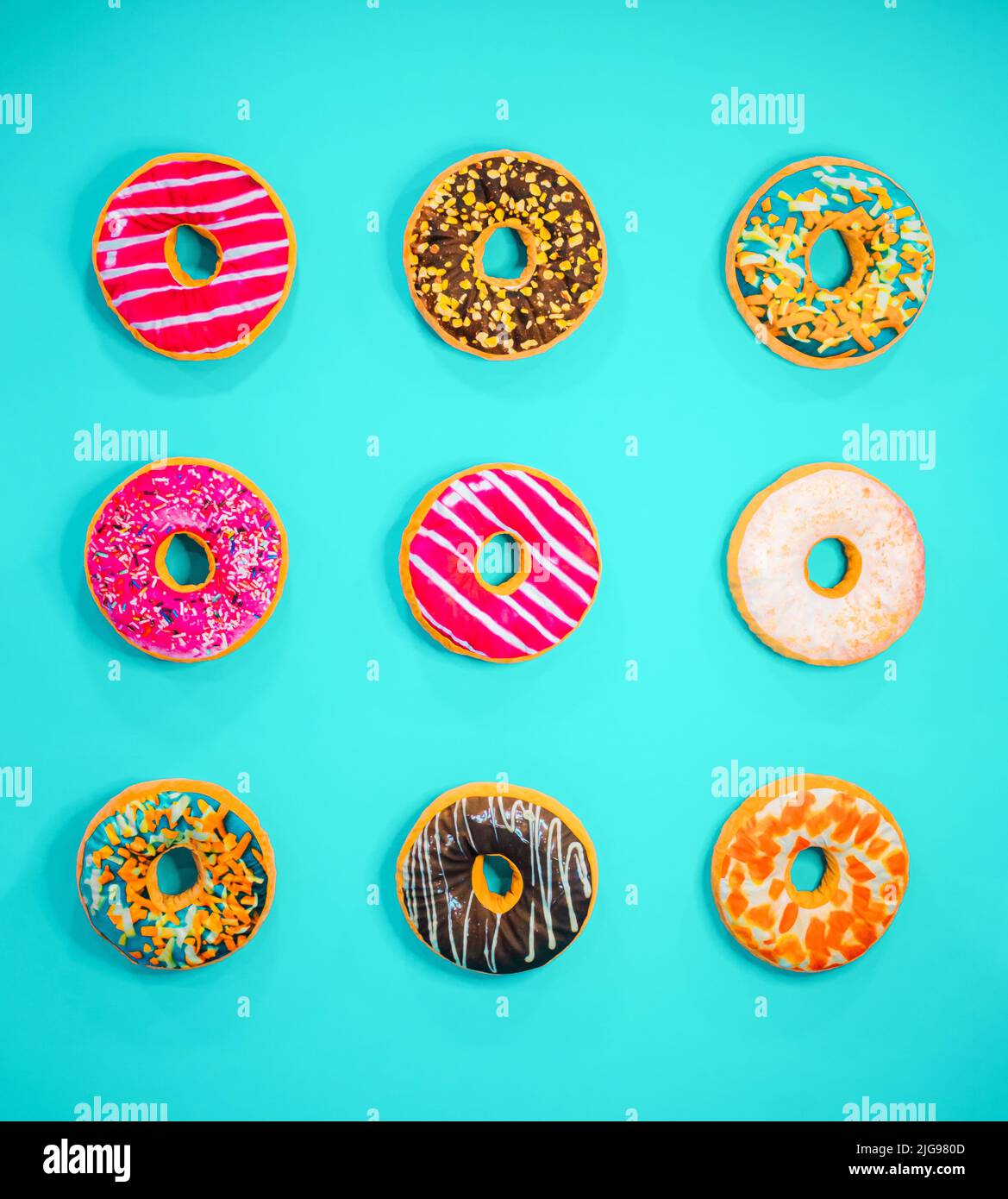 Set of 9 different colorful donuts isolated on blue background. In ...