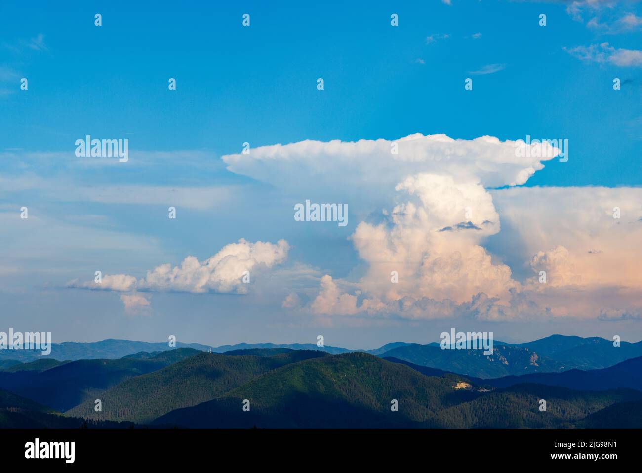 Huge majestic multi-colored and white clouds stretch across the bright ...