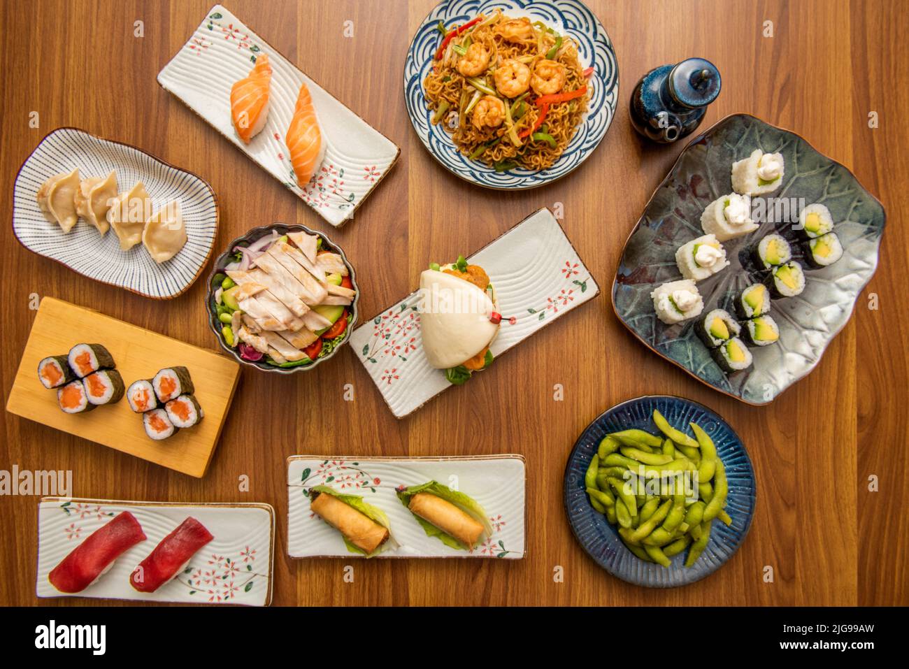 set of asian food dishes with sushi, avocado maki, shrimp noodles, soy ...