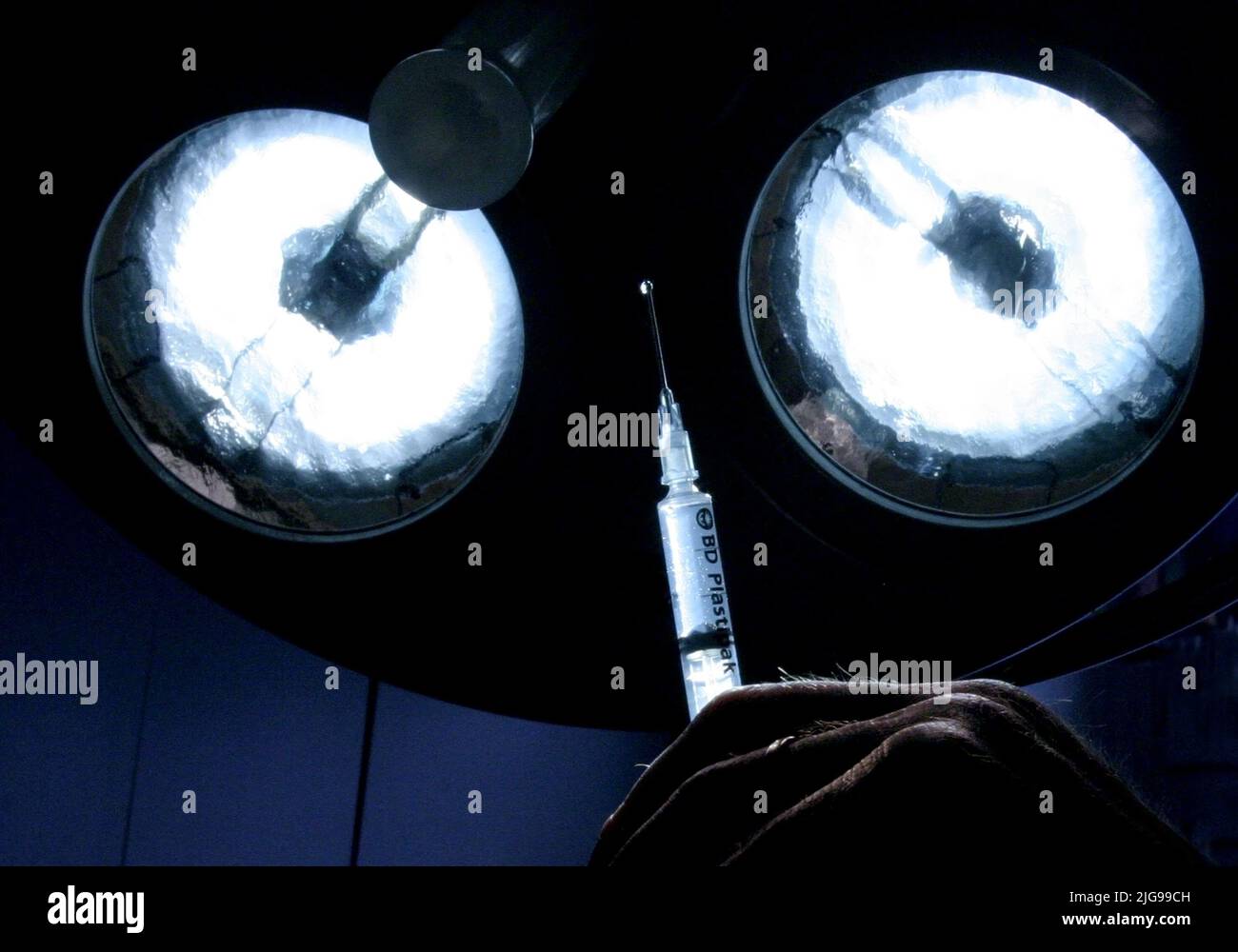 A nurse at a health center preparing a syringe for surgery Stock Photo ...