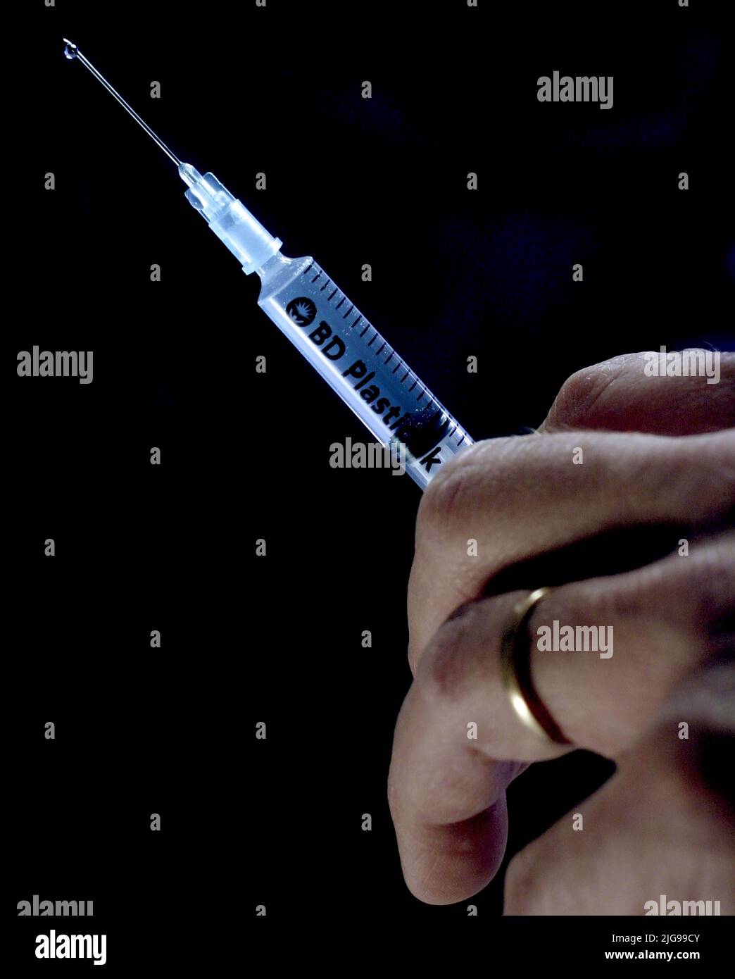 A nurse at a health center preparing a syringe for surgery Stock Photo ...