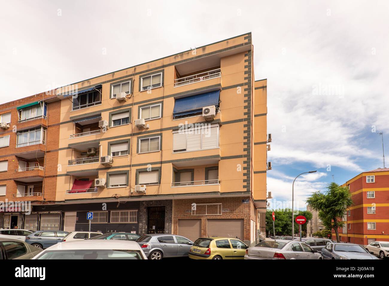 Facades of urban residential buildings with terraces on a cloudy and ...