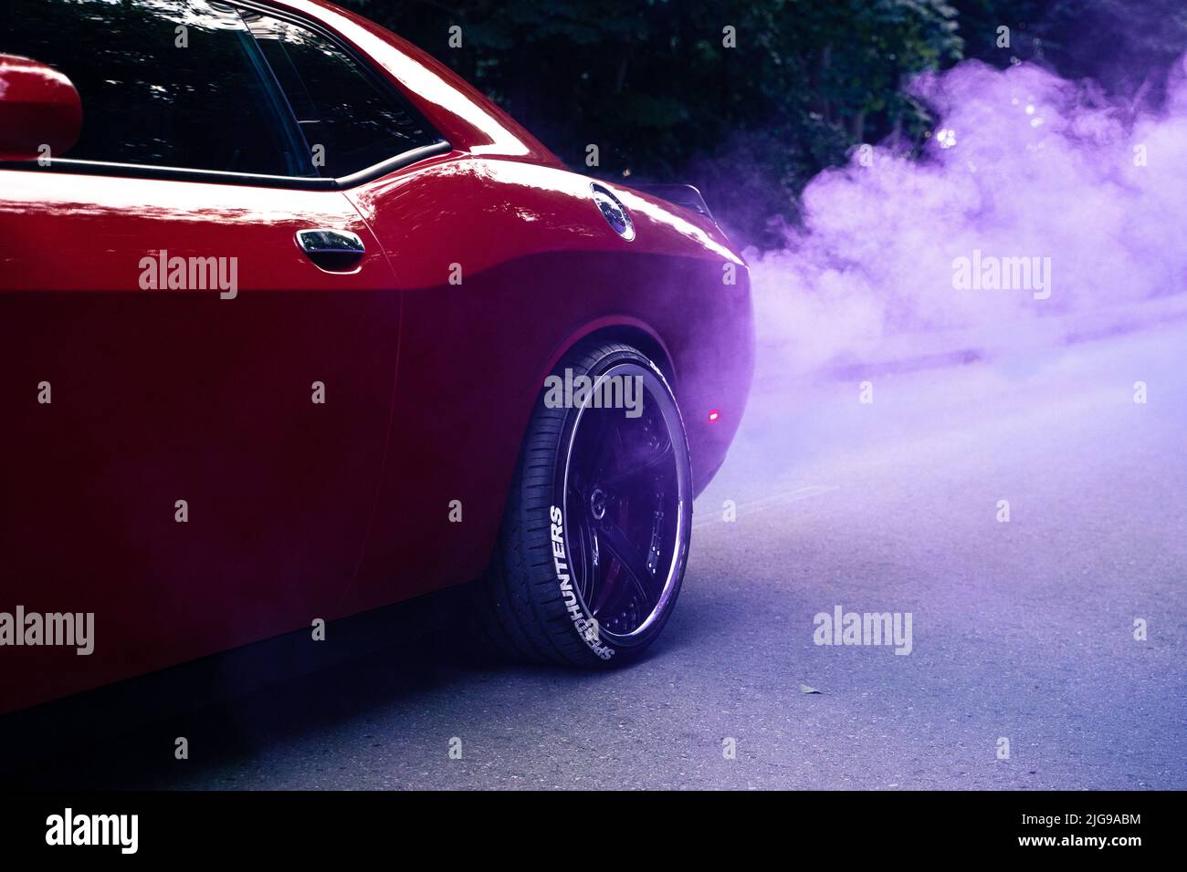 A Dodge Challenger sports muscle car red with racing smoke red purple ...