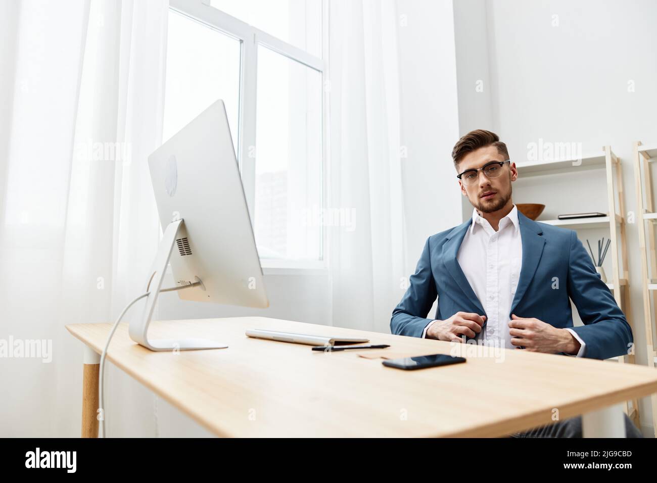 a man in a suit at the desk in the office an official executive Stock ...