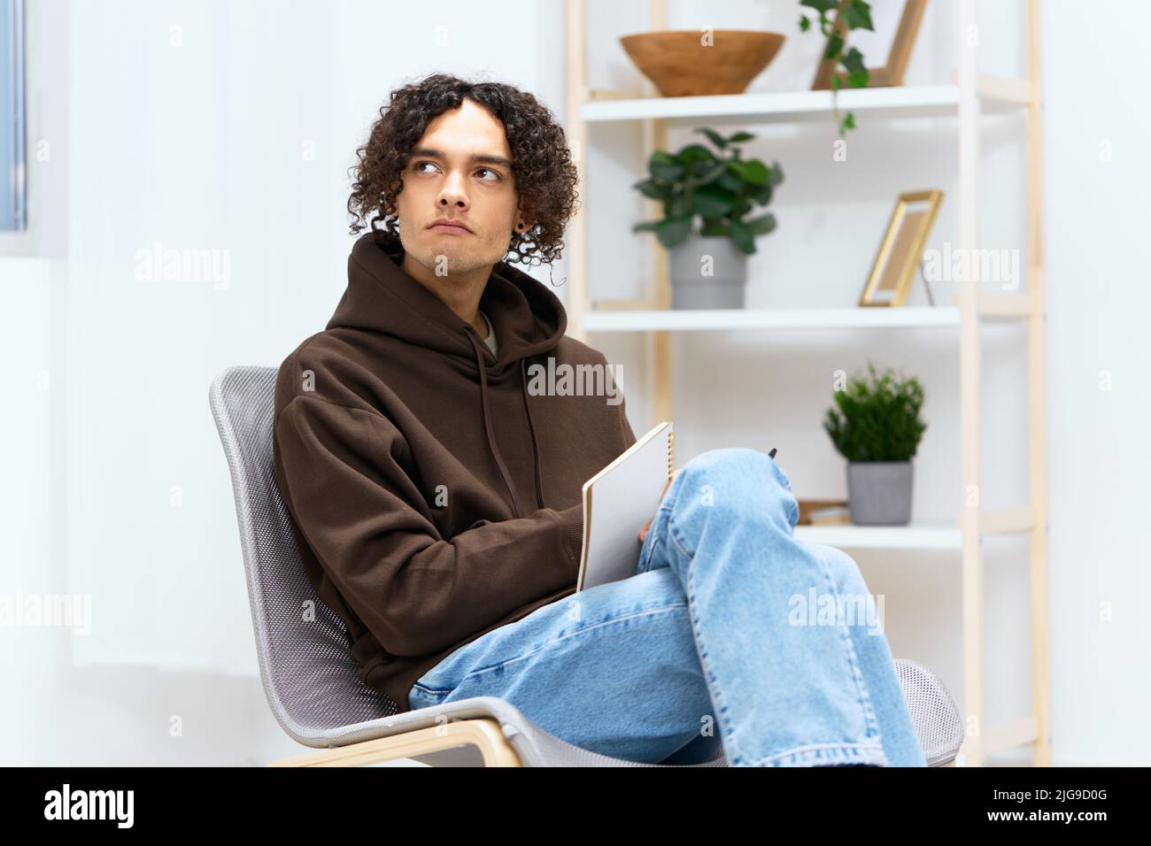 A young man writing down ideas with a notepad isolated background Stock ...
