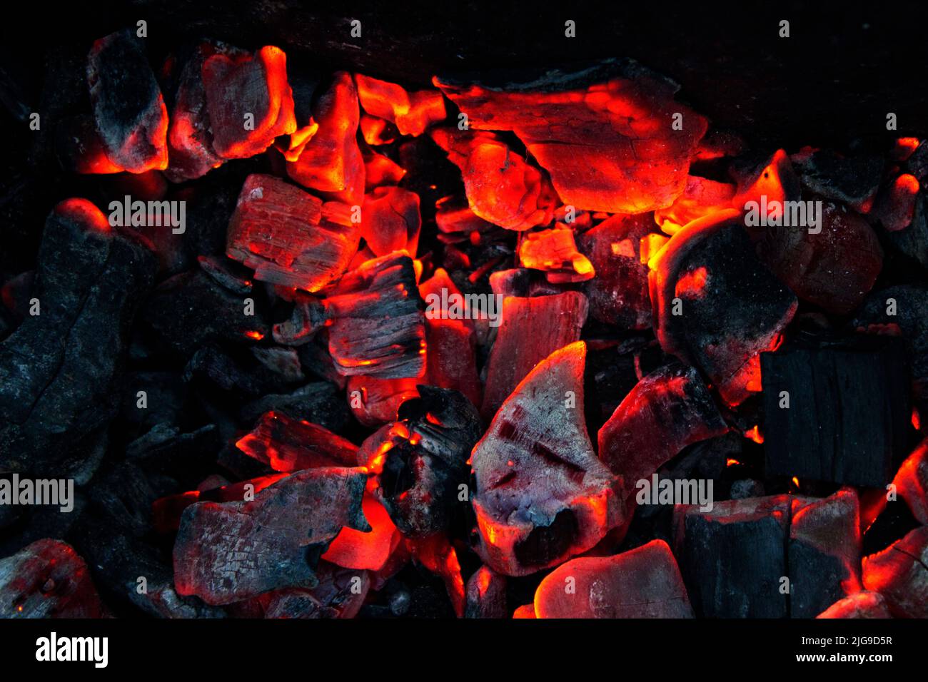 Actively smoldering embers of fire. Background of burning hot coals ...