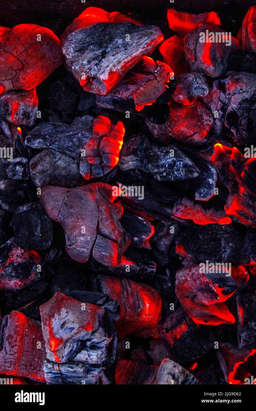 Actively smoldering embers of fire. Background of burning hot coals ...