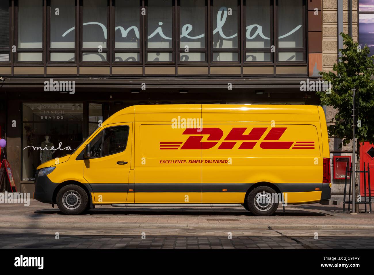 An iconic yellow DHL delivery truck parked in Tampere Stock Photo - Alamy