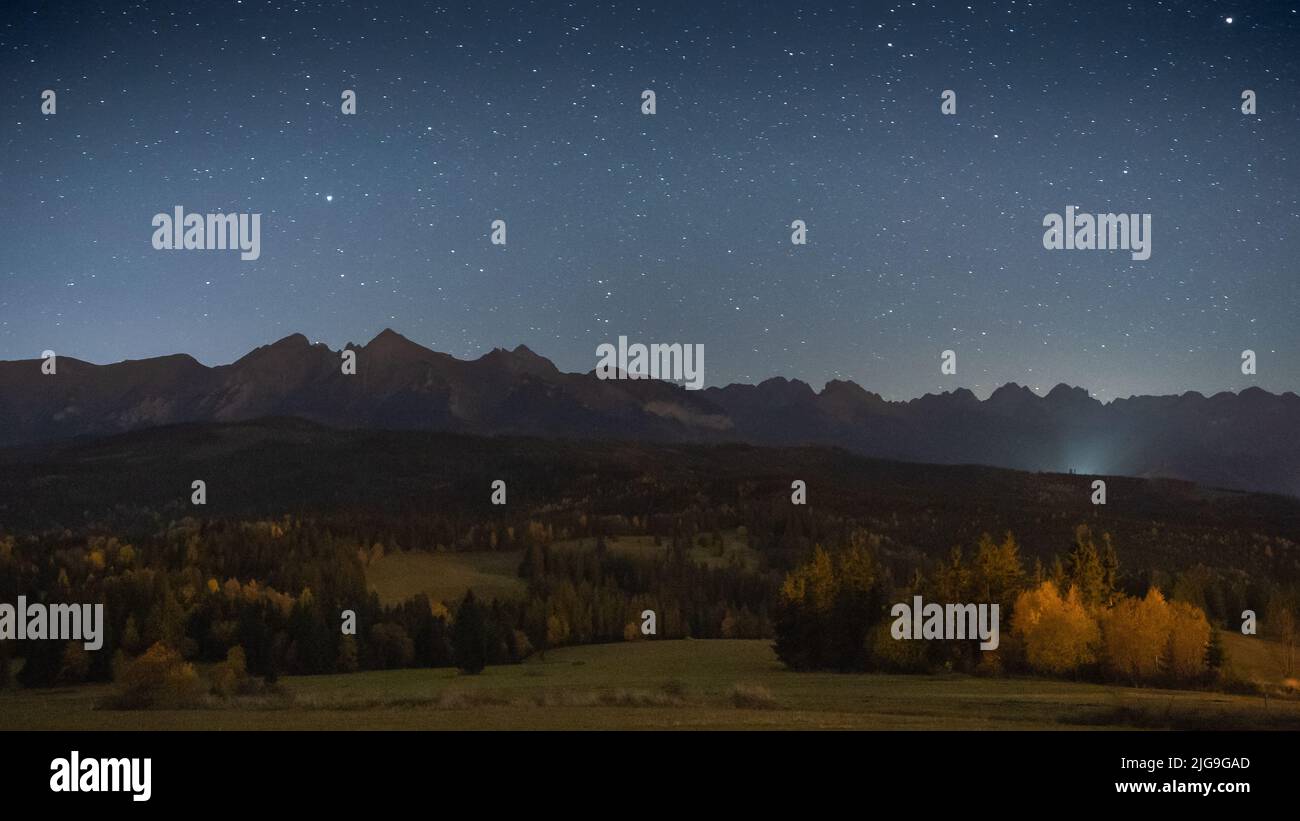 Beautiful night landscape with sky full of stars above rocky mountain ...