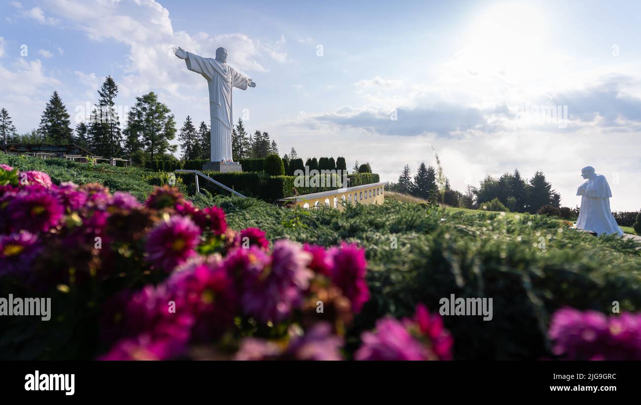 Statues of Jesus and pope forming religious monument surrounded by ...