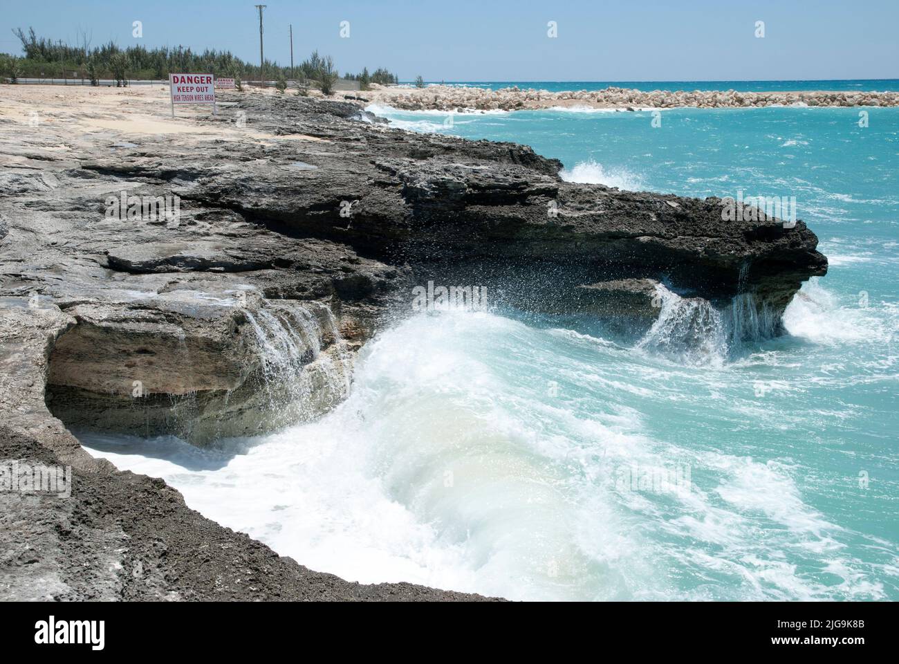 The view of waves washing eroded Grand Bahama island shore and warning ...
