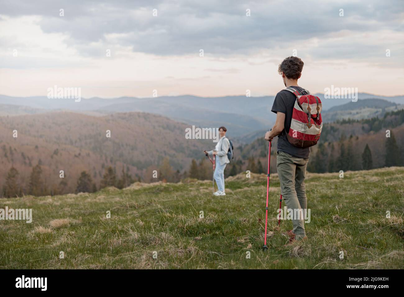 Rear of young people walking the mountains chain peak and enjoying ...
