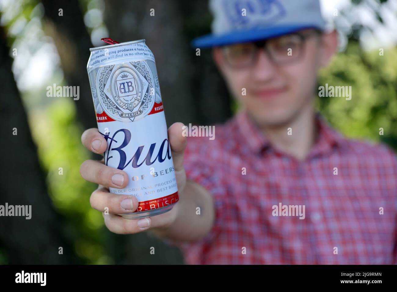 SUMY, UKRAINE - AUGUST 01, 2021: Young man raise Budweiser Bud beer can ...