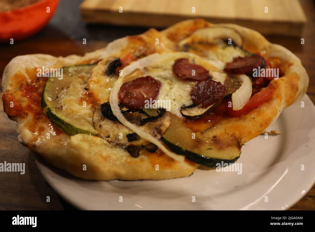 Homemade pizza in wooden fire in open construction. All ingredients ...