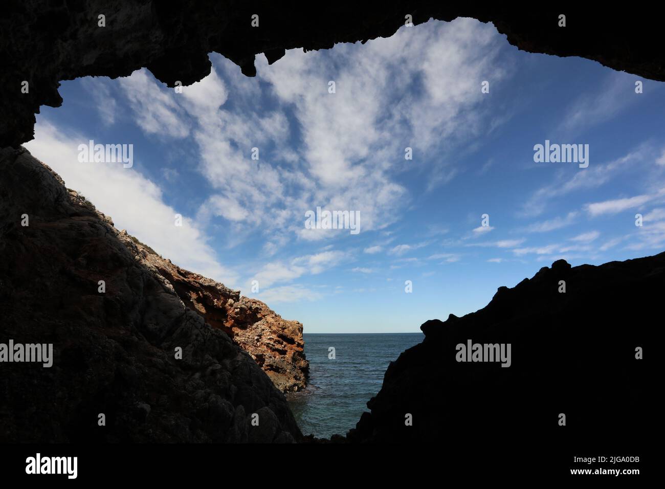 Hidden beach by the ocean sea with natural caves, sand and cliff Stock ...