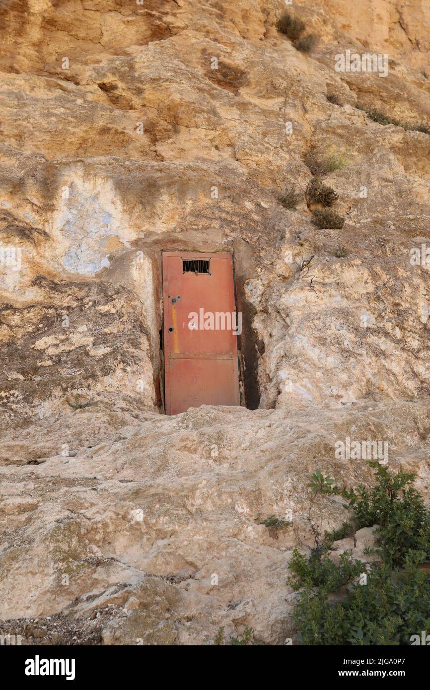 Door entrance of the natural caves in the cliff big rock in Almeria ...