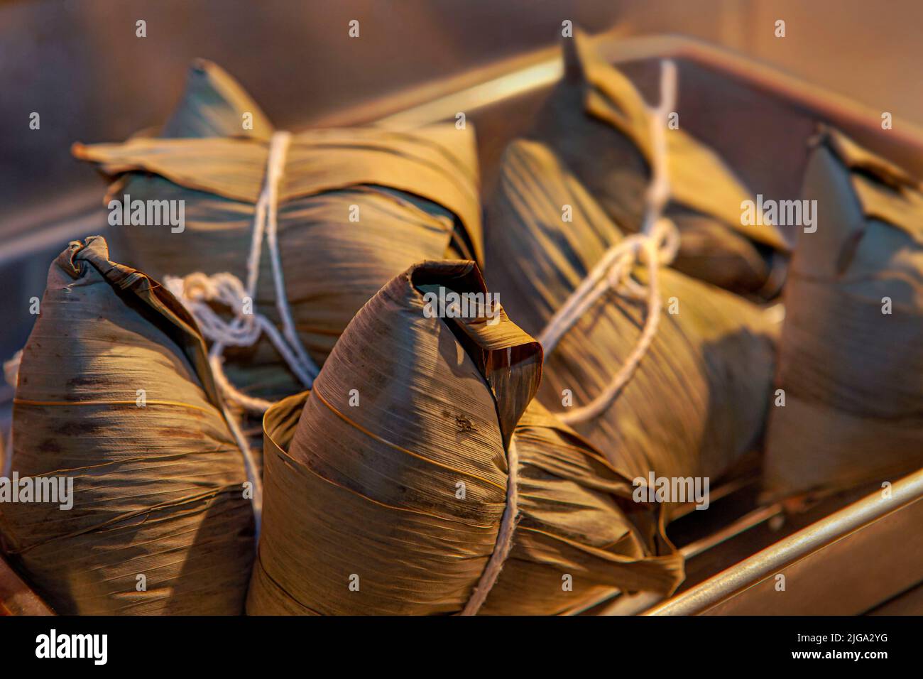 Close up look of bamboo leaf wrapped steamed pork rice, ready for sale ...