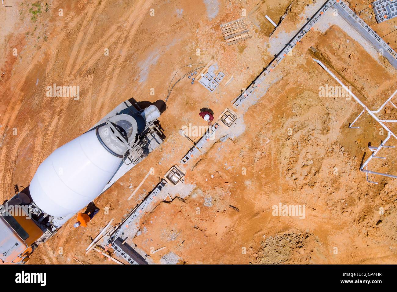 Workers pouring concrete columns on a new structure in construction ...