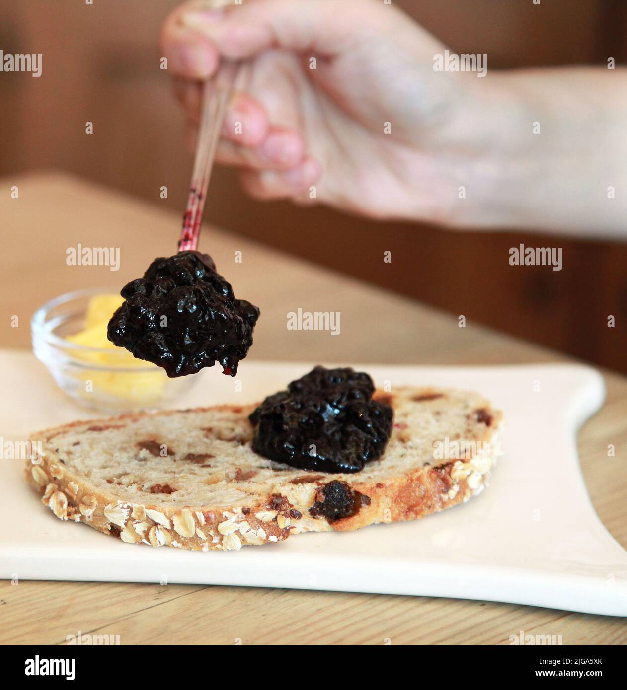 Blueberry jam and butter with raisin bread on the breakfast plate Stock ...