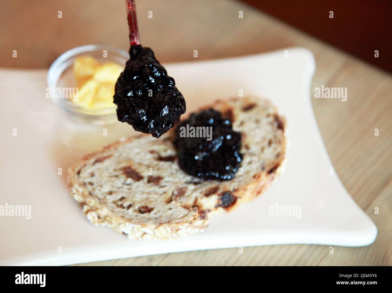 Blueberry jam and butter with raisin bread on the breakfast plate Stock ...