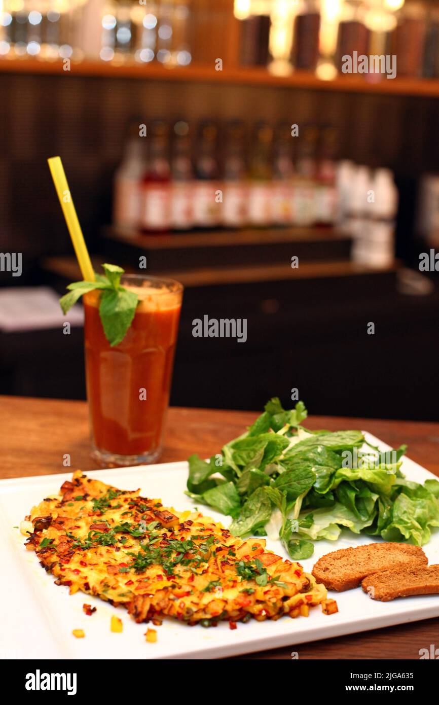 Mixed omelette with vegetables and smoothie on the restaurant table ...