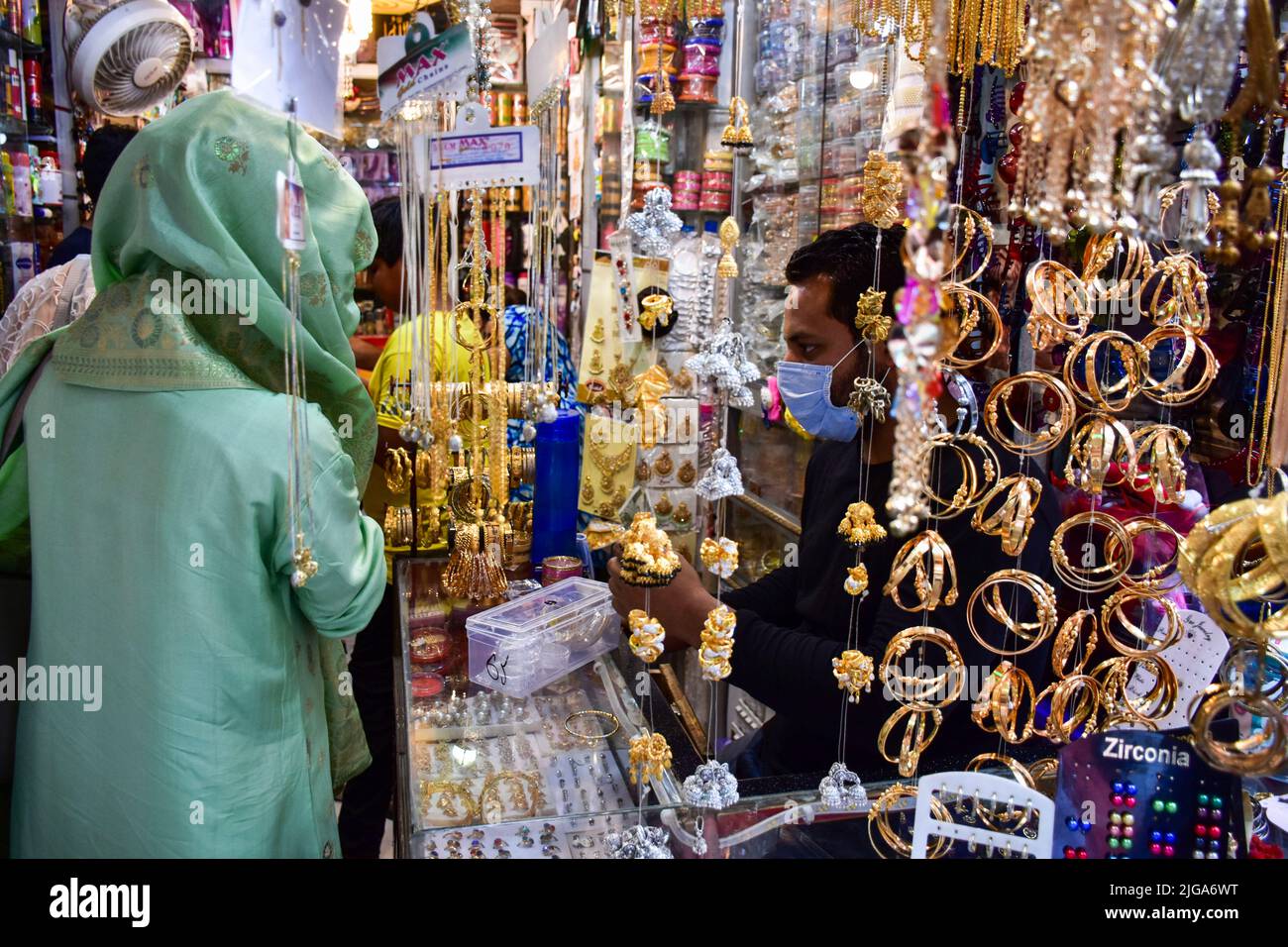Srinagar, India. 08th July, 2022. A Kashmiri woman shops at a jewelry ...