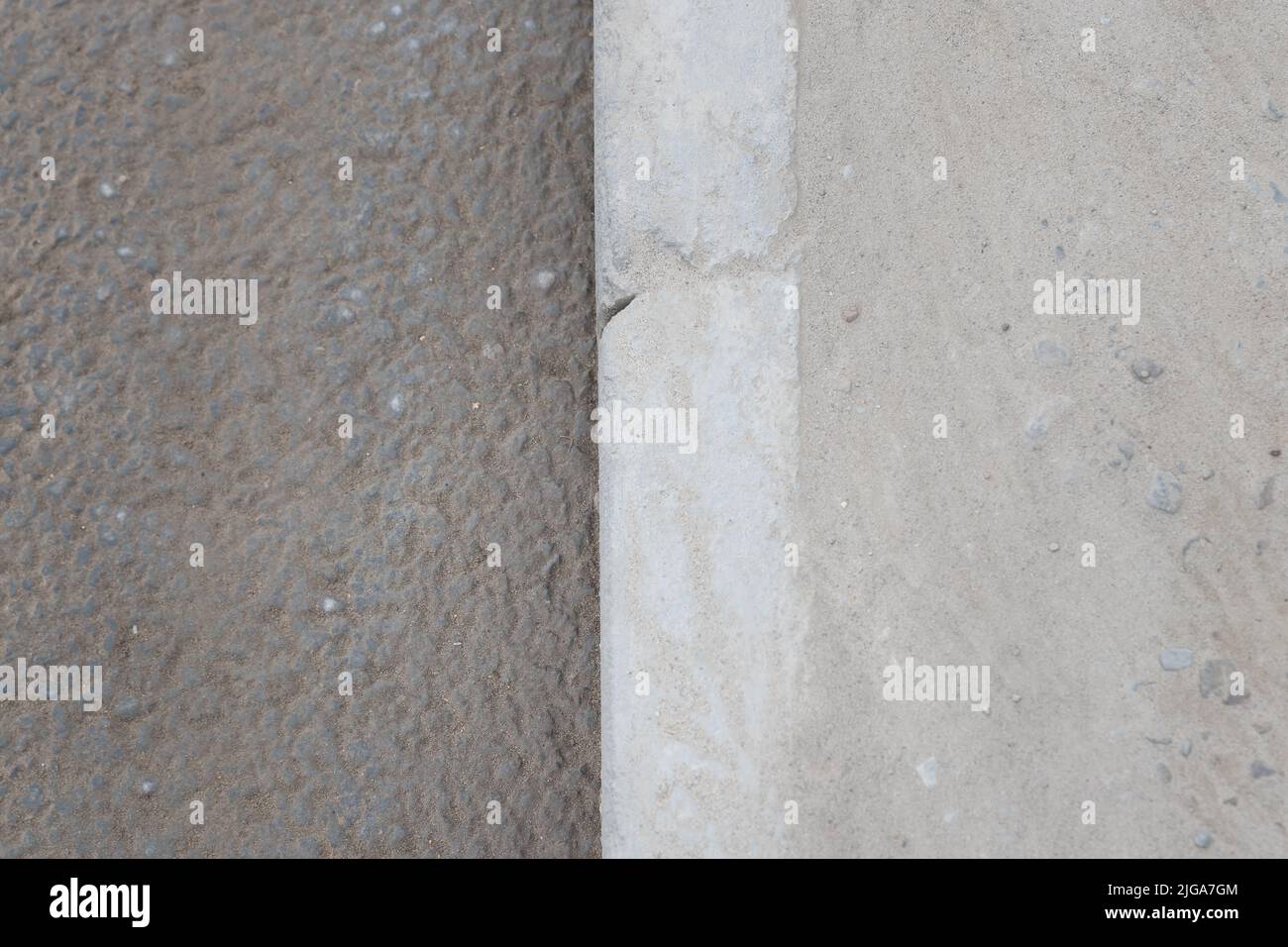 The boundary between the gray asphalt and the curb Stock Photo - Alamy