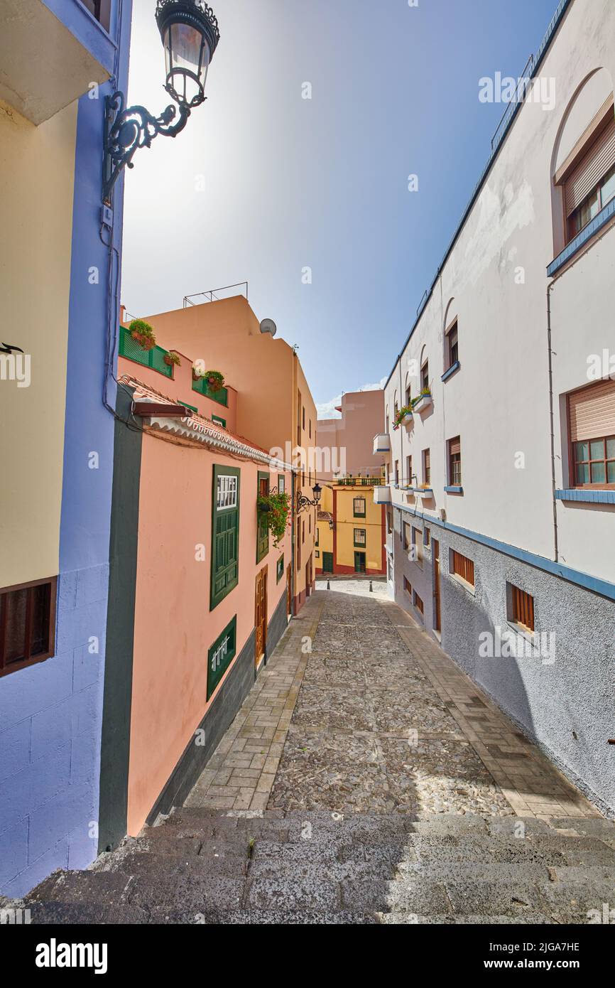 Narrow street with colorful houses and a blue sky. Architecture of tiny ...