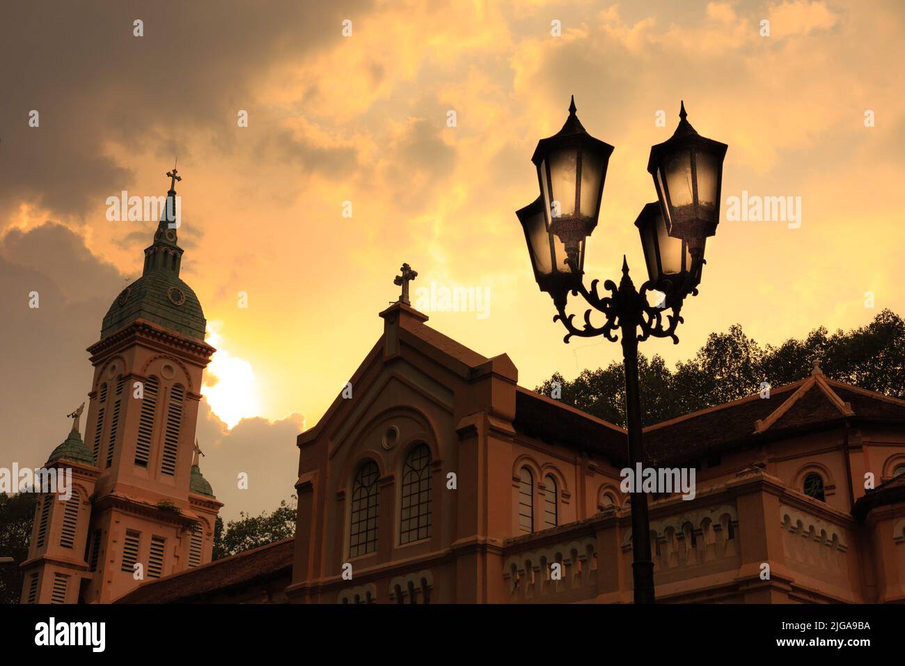 The towers of a church with the magic clouds at sunset in HCMC, Vietnam ...