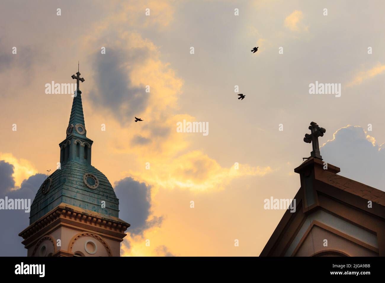 The towers of a church with the magic clouds at sunset in HCMC, Vietnam ...