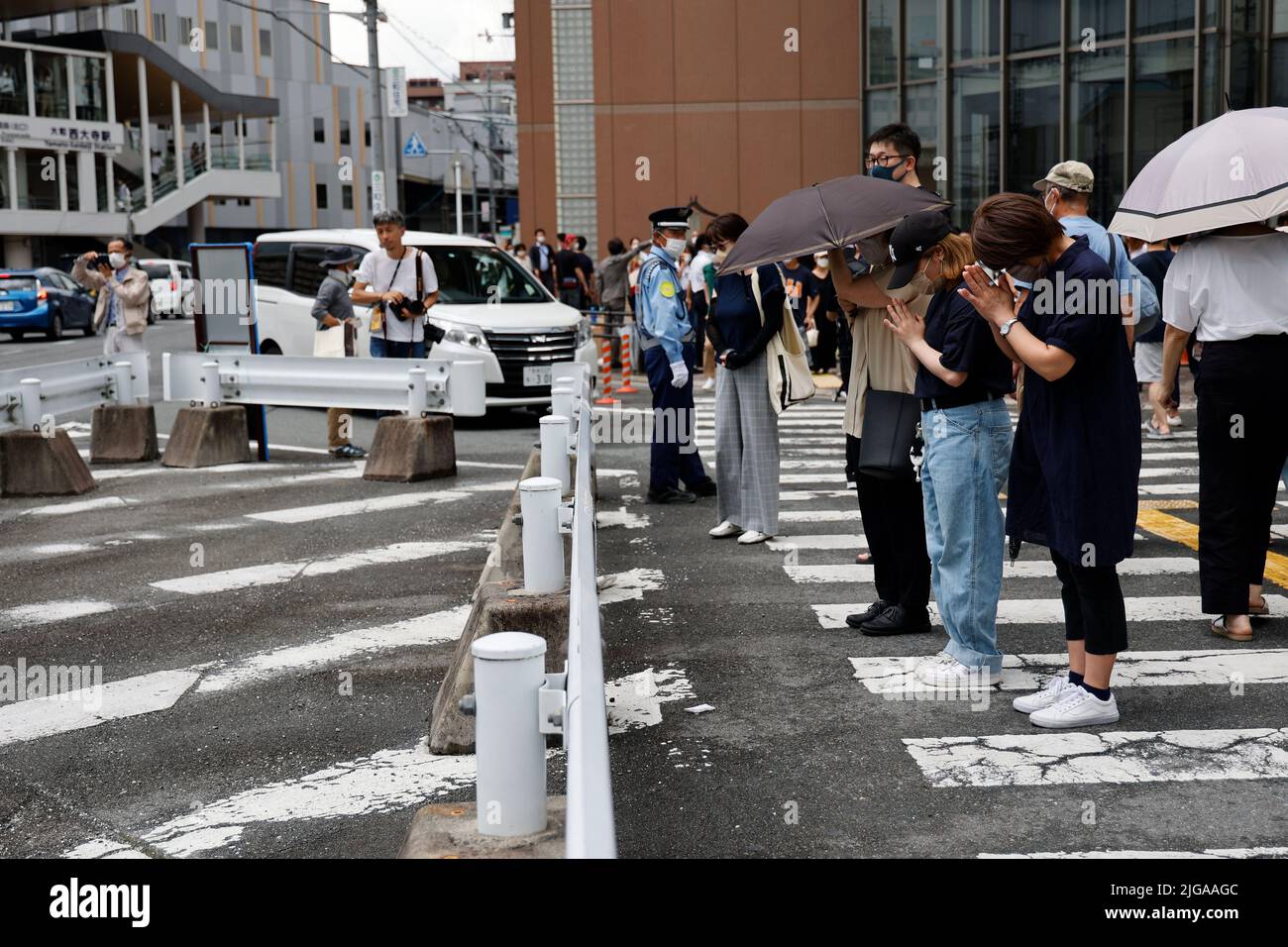 Nara, Nara, Japan. 9th July, 2022. People wearing face masks offer a ...