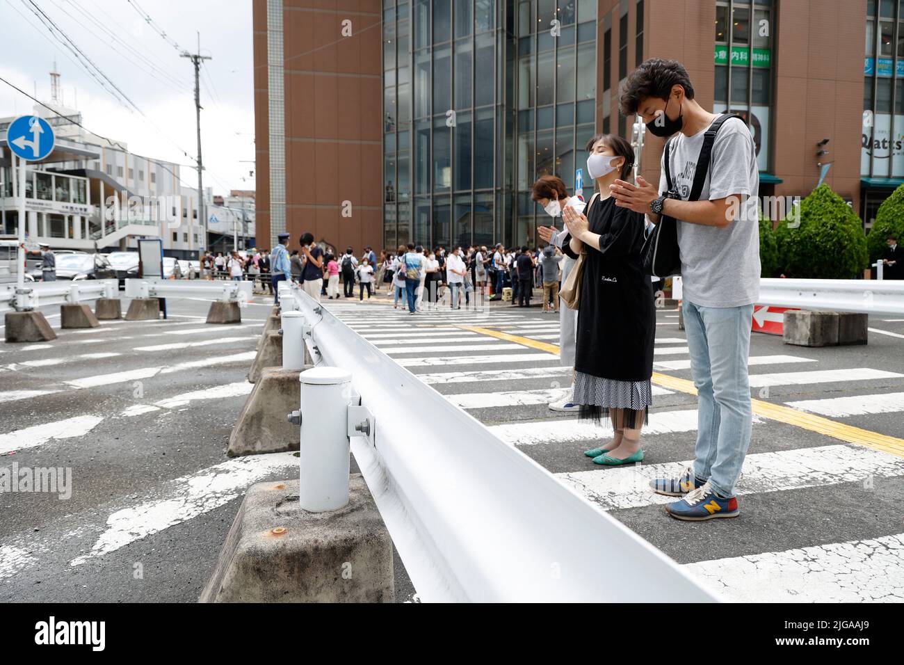Nara, Nara, Japan. 9th July, 2022. People wearing face masks offer a ...