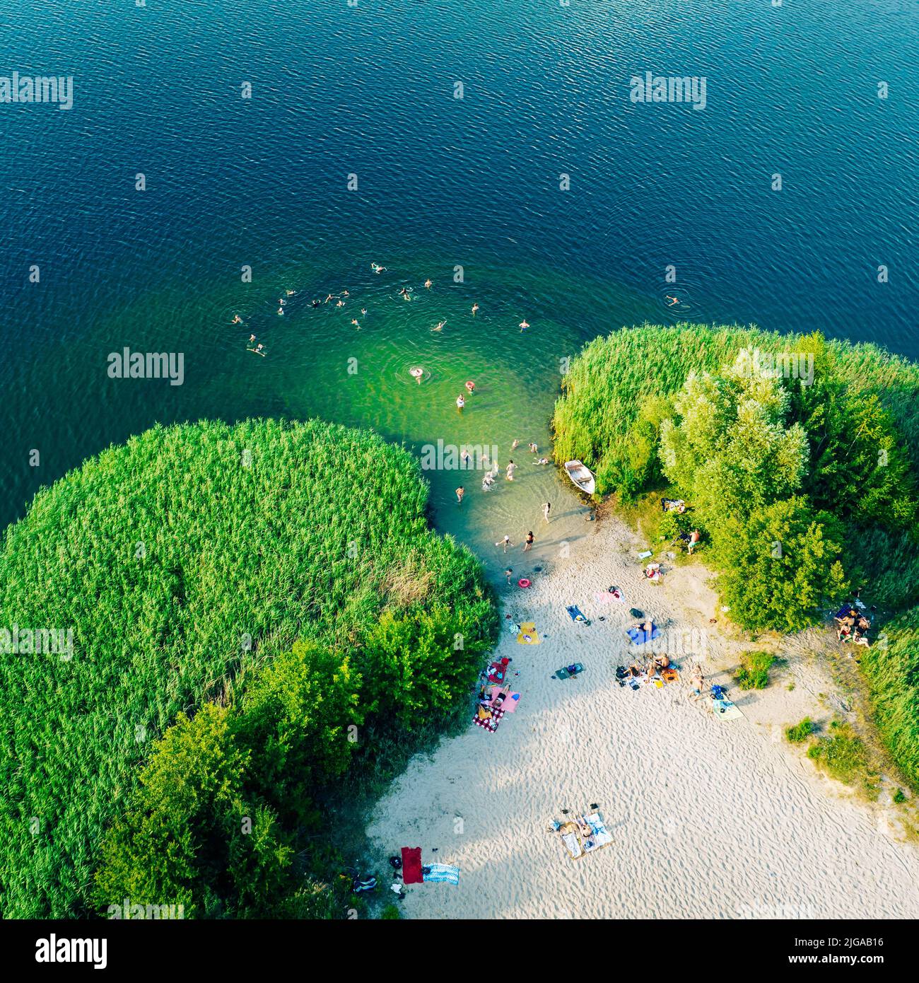 Summer time at the lake. Rest on the beach. Aerial view of small hidden ...