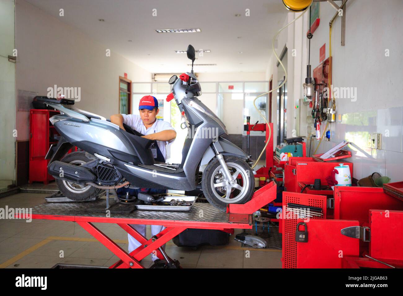 Professional motorcycle repairman at a service center of Honda ...
