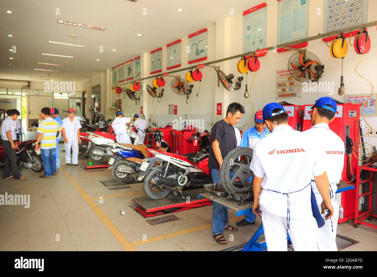 Professional motorcycle repairman at a service center of Honda ...