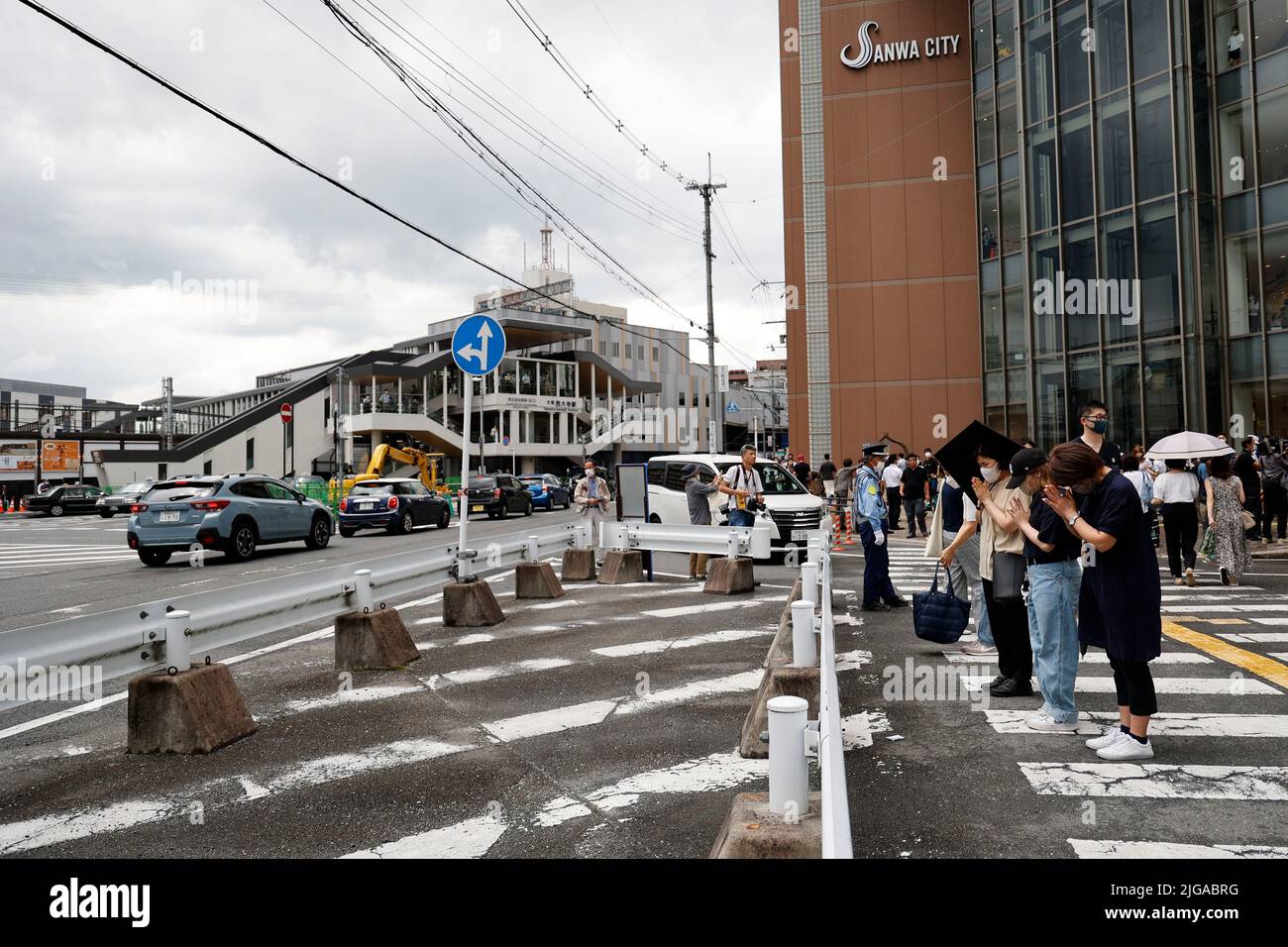 Nara, Nara, Japan. 9th July, 2022. People wearing face masks offer a ...