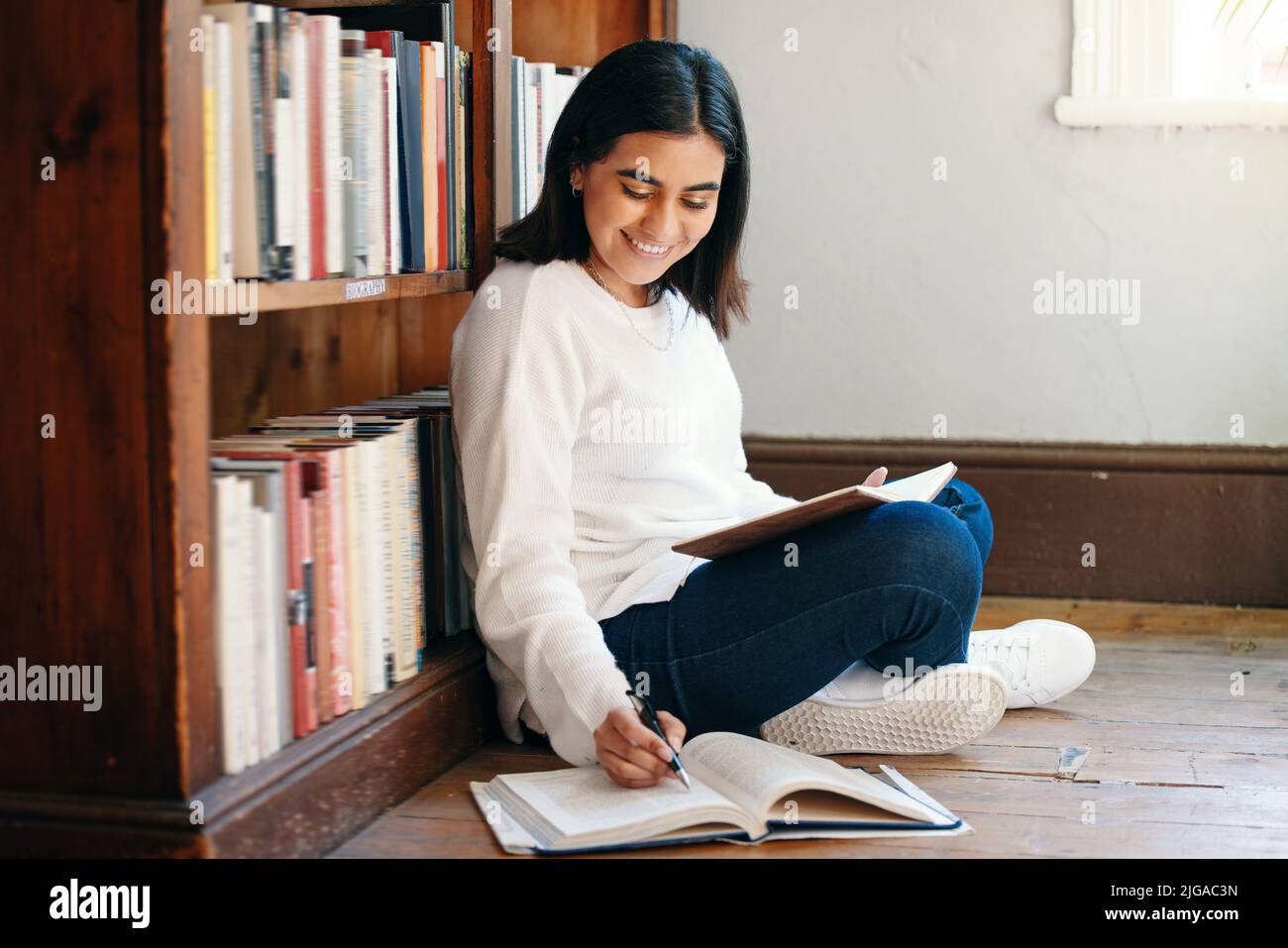 Working toward my goals. a young female student working in her school ...