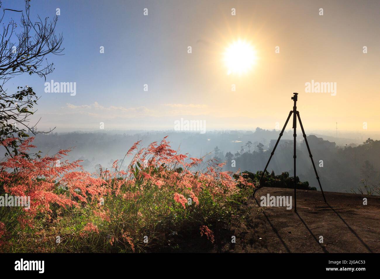 Tripod on the peak ready for photography. foggy background, the fog is ...