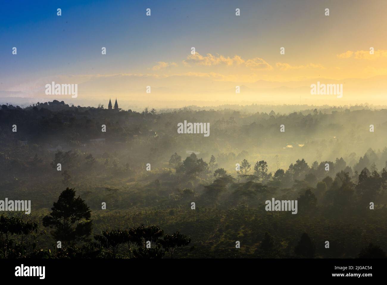 Sun rays at the valley on Bao Loc town. The far side is Thanh Xa Church ...