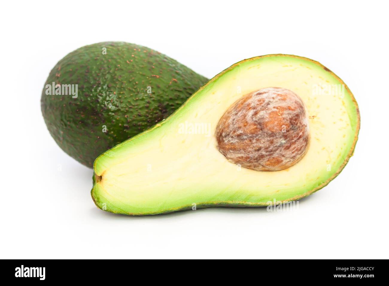 Cut and whole ripe avocadoes on white background Stock Photo - Alamy