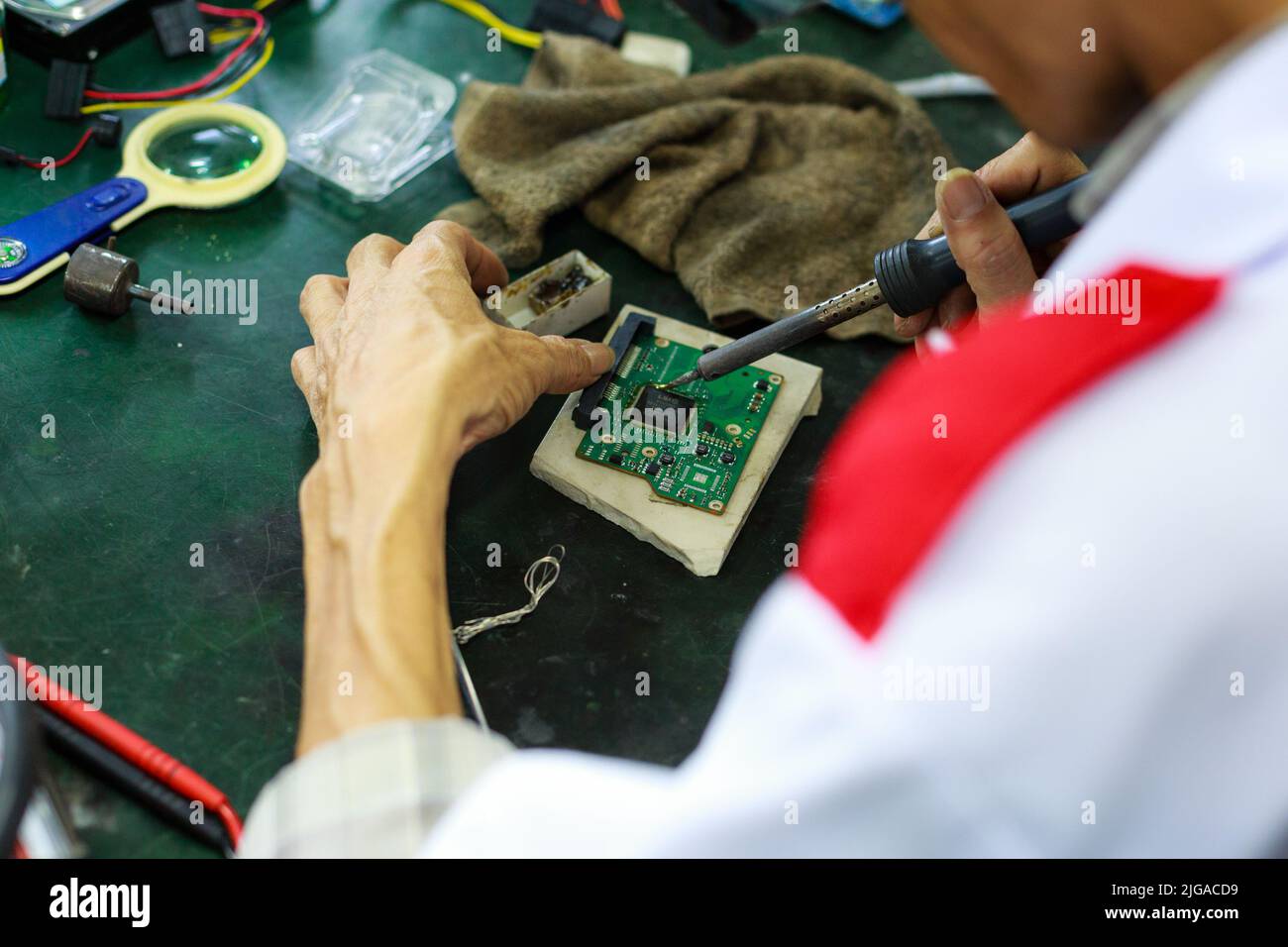 technicians are checking a customer's computer for repair at a computer ...