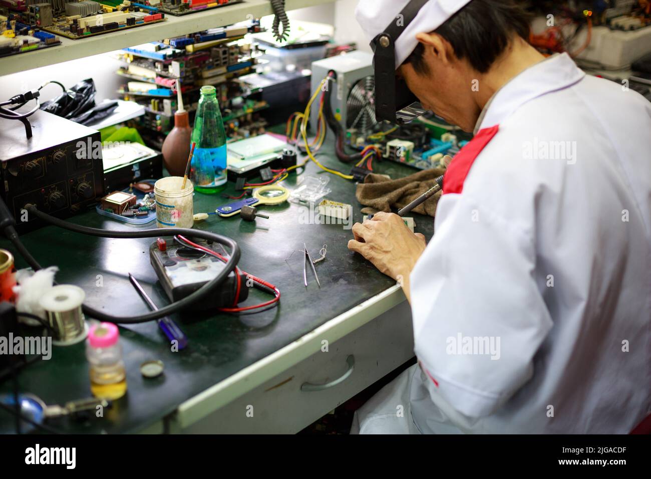 technicians are checking a customer's computer for repair at a computer ...